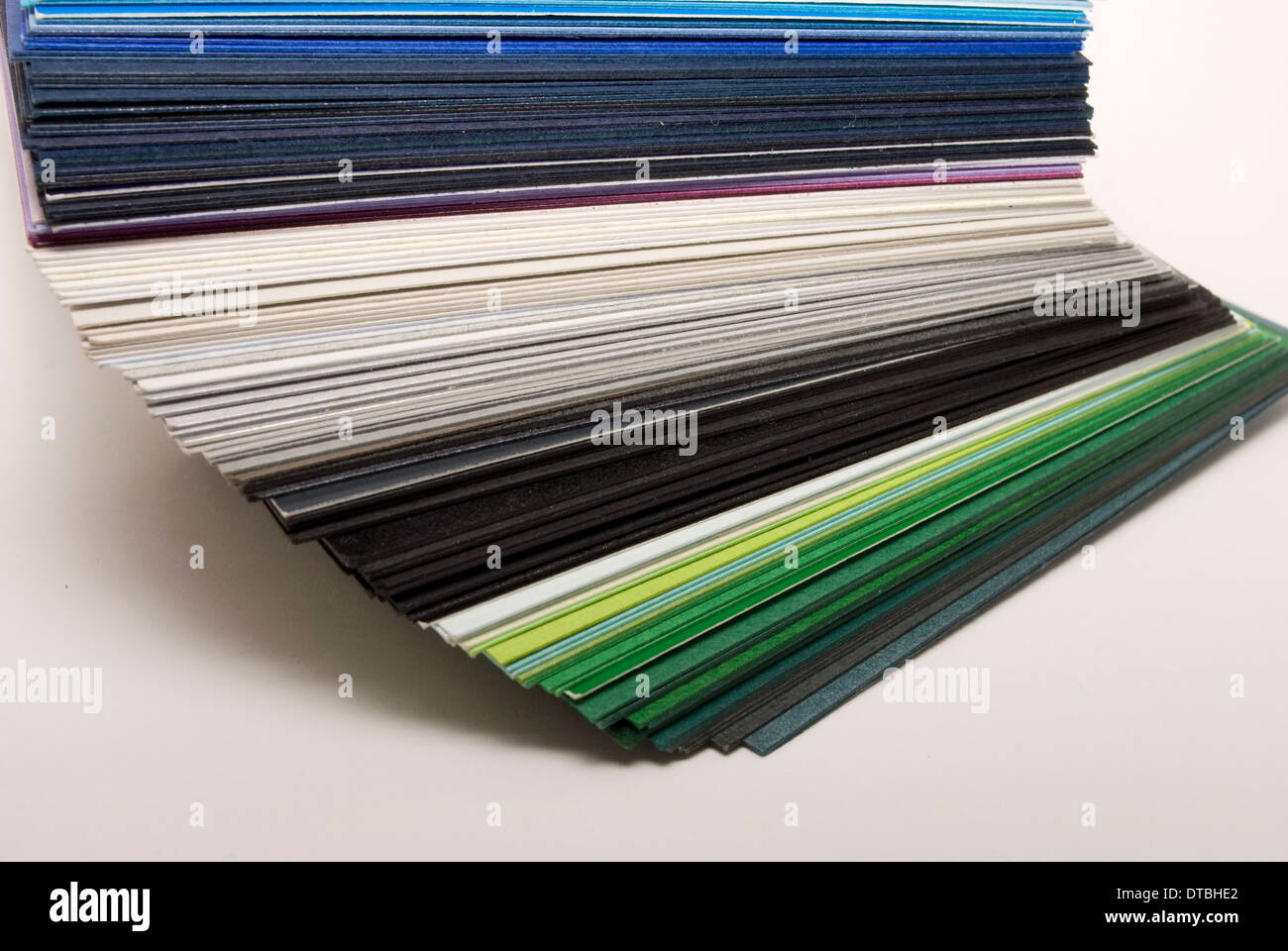 Colored paper stock stand on white background Stock Photo - Alamy