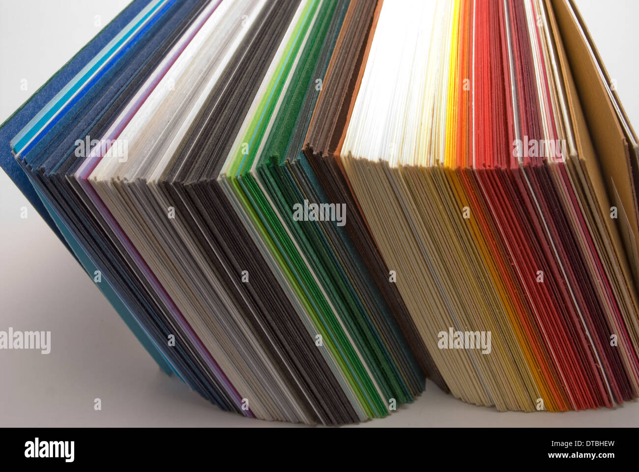 Colored paper stock stand on white background Stock Photo - Alamy