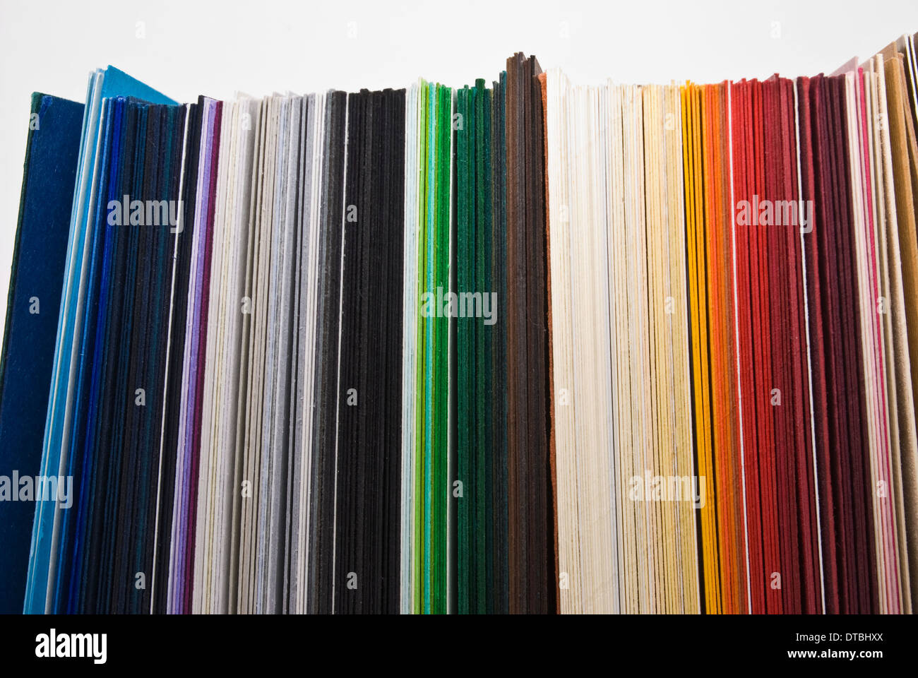 Colored paper stock stand on white background Stock Photo - Alamy