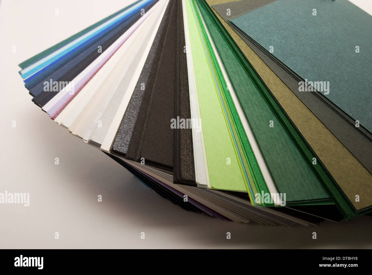 Colored paper stock stand on white background Stock Photo - Alamy