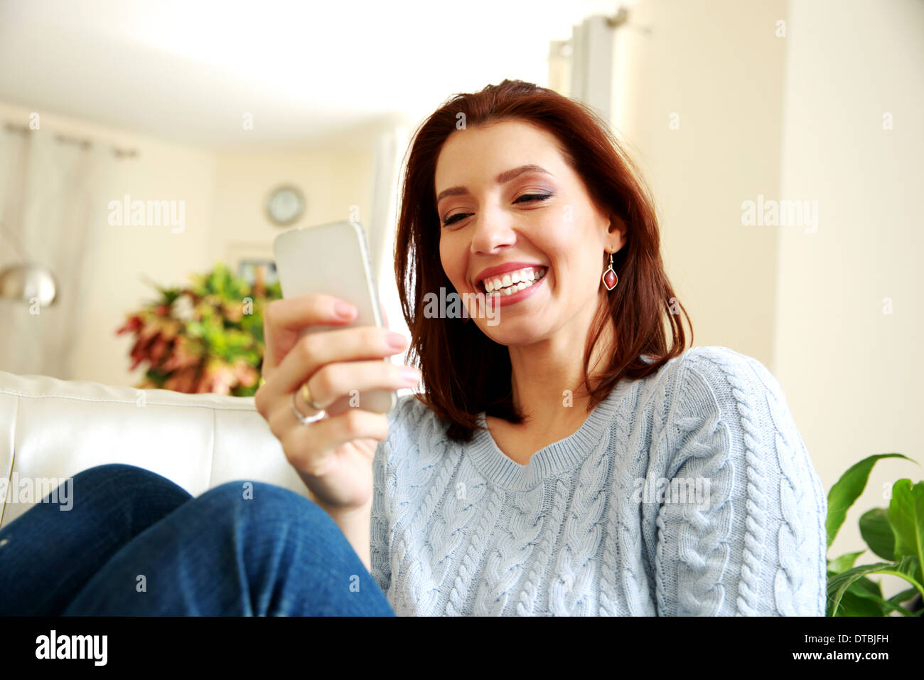 Laughing woman using smartphone hi-res stock photography and images - Alamy