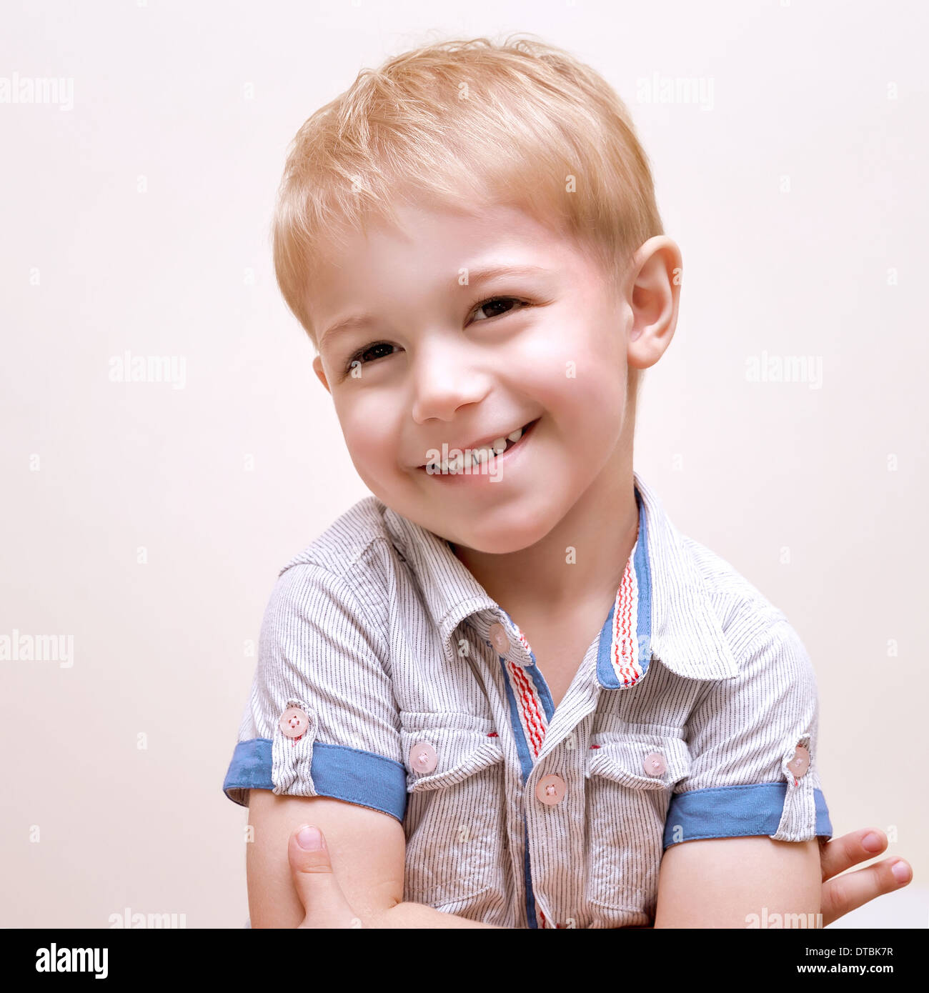 Portrait of happy smiling boy isolated on beige background, studio shot ...