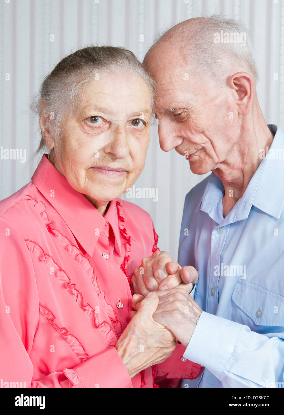 Closeup portrait of smiling elderly couple Old people holding hands ...