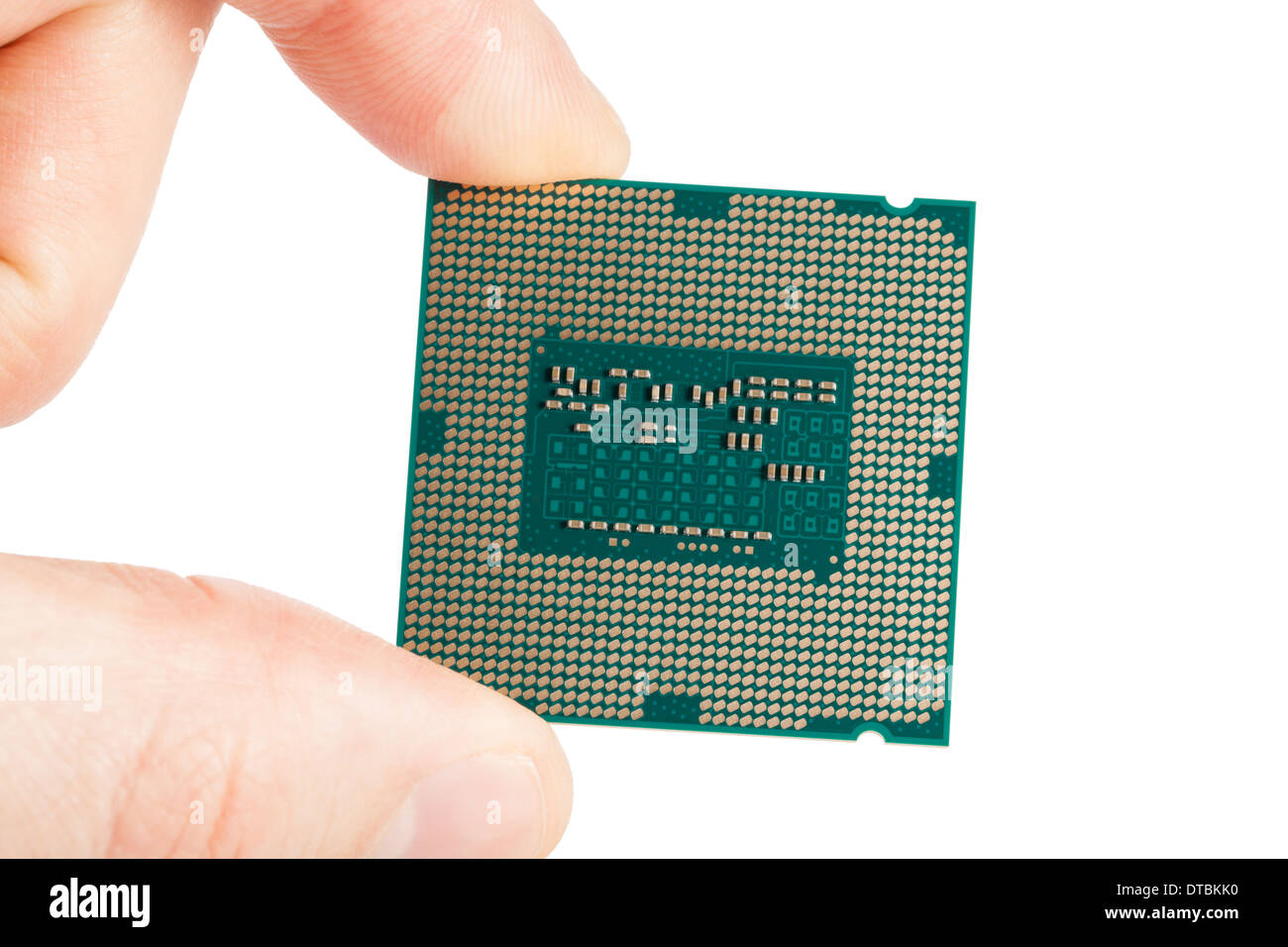 Macro of a computer's processor in hand isolated on a white background ...