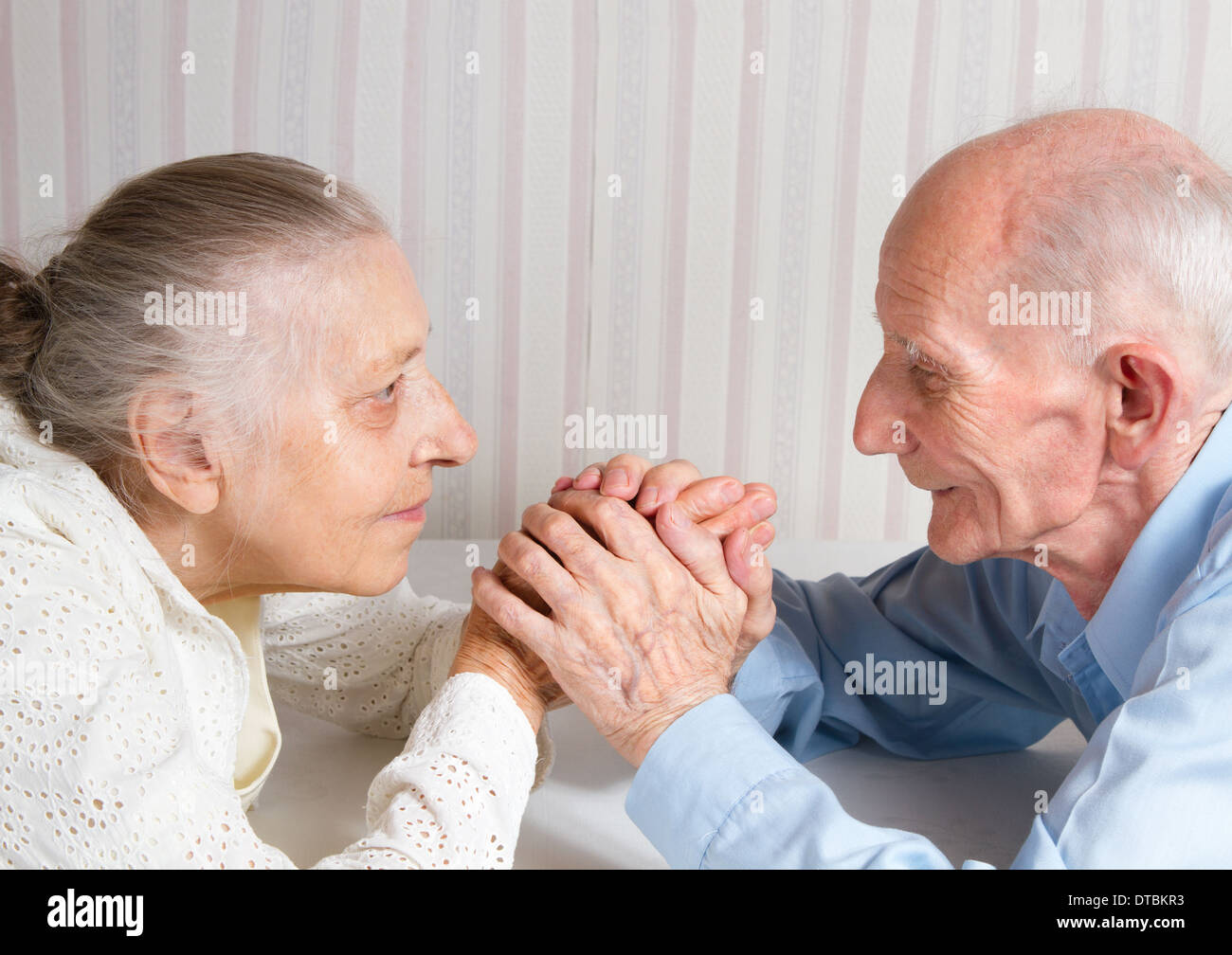 Closeup portrait of smiling elderly couple Old people holding hands ...