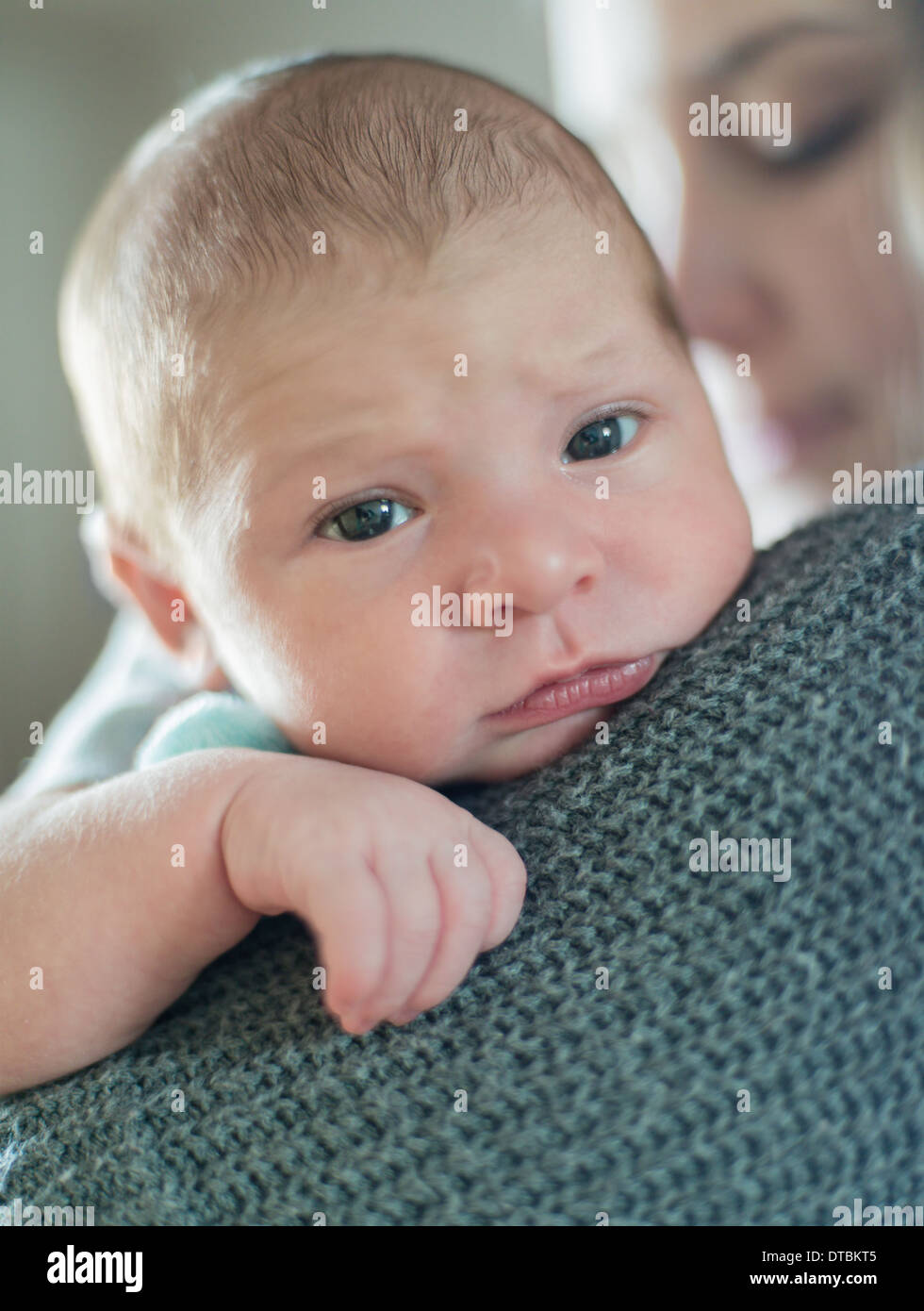 Selective focus portrait of a serious baby on his mother Stock Photo ...