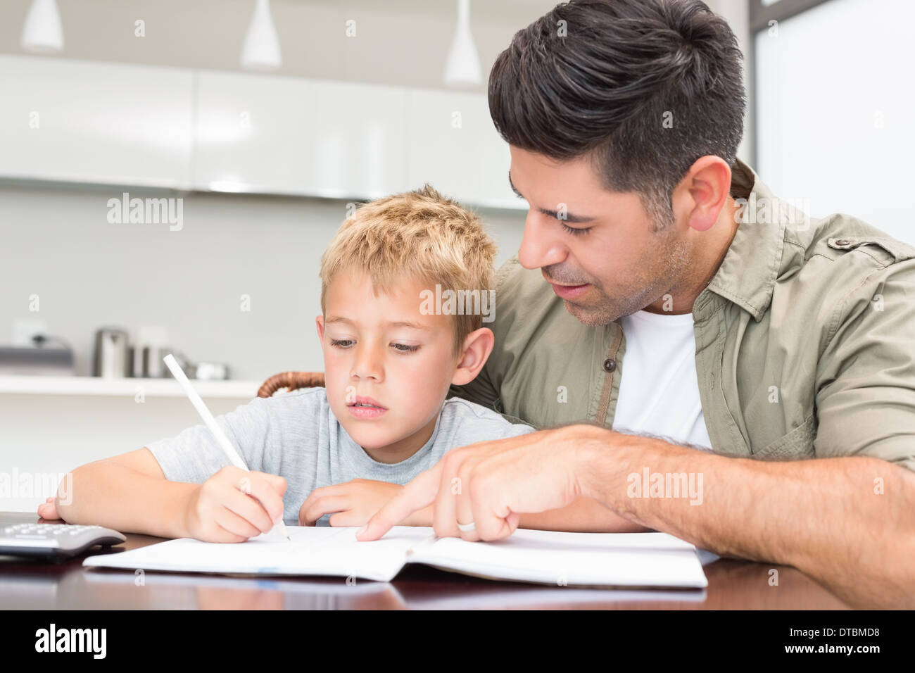 Father helping son with his math homework Stock Photo - Alamy
