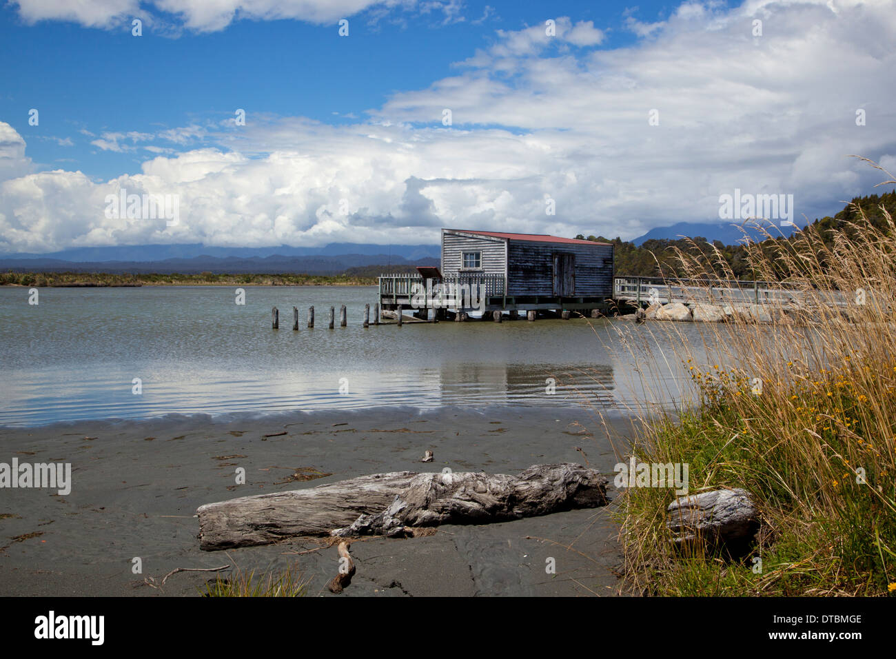 Old Wharf building Okarito Lagoon, looking towards southern alps ...