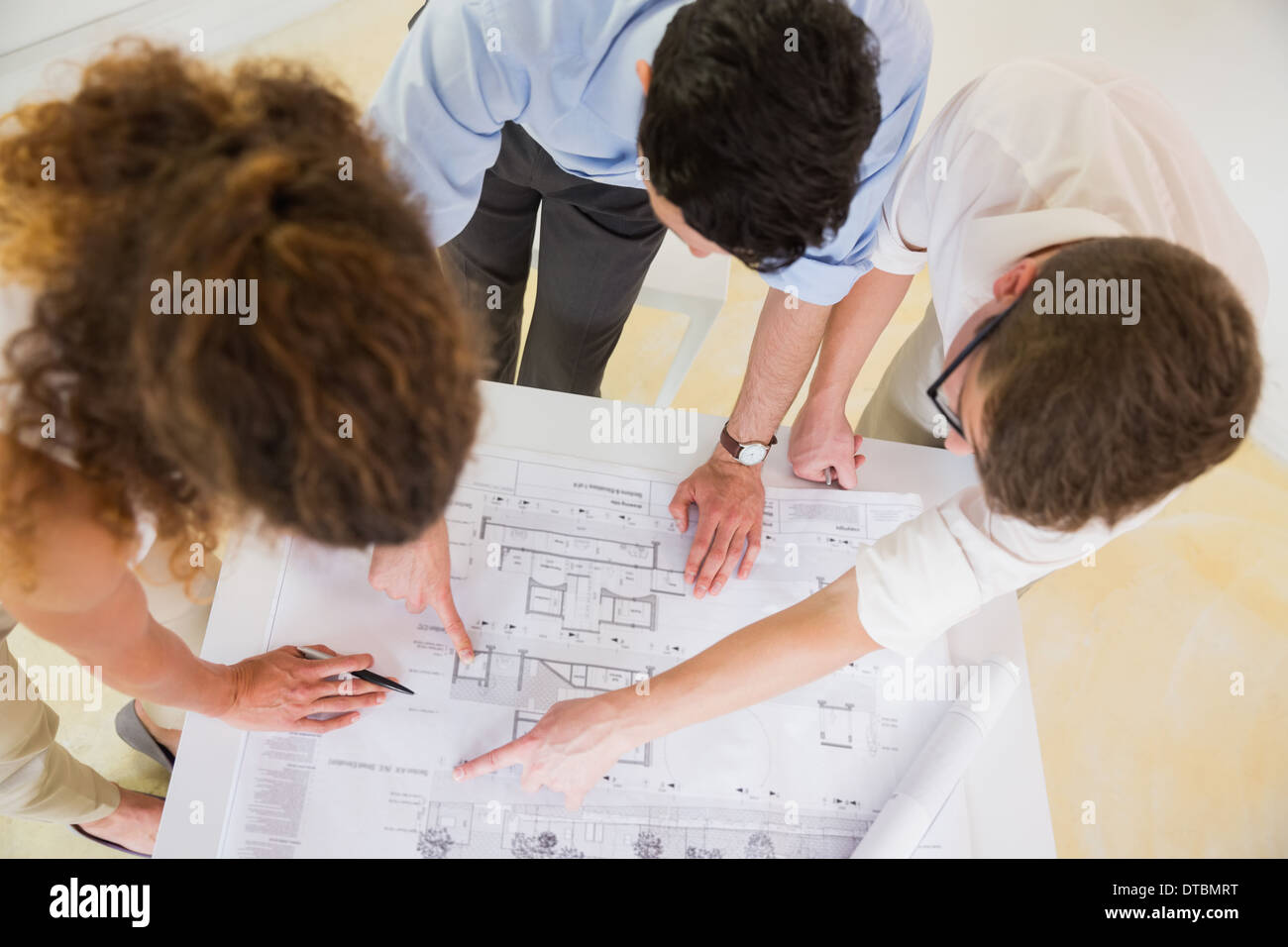 Business people analyzing blueprint Stock Photo - Alamy