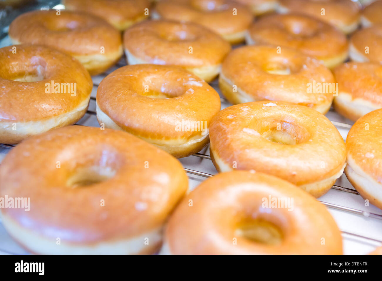 Fresh raised donuts from the local bakery shop Stock Photo - Alamy