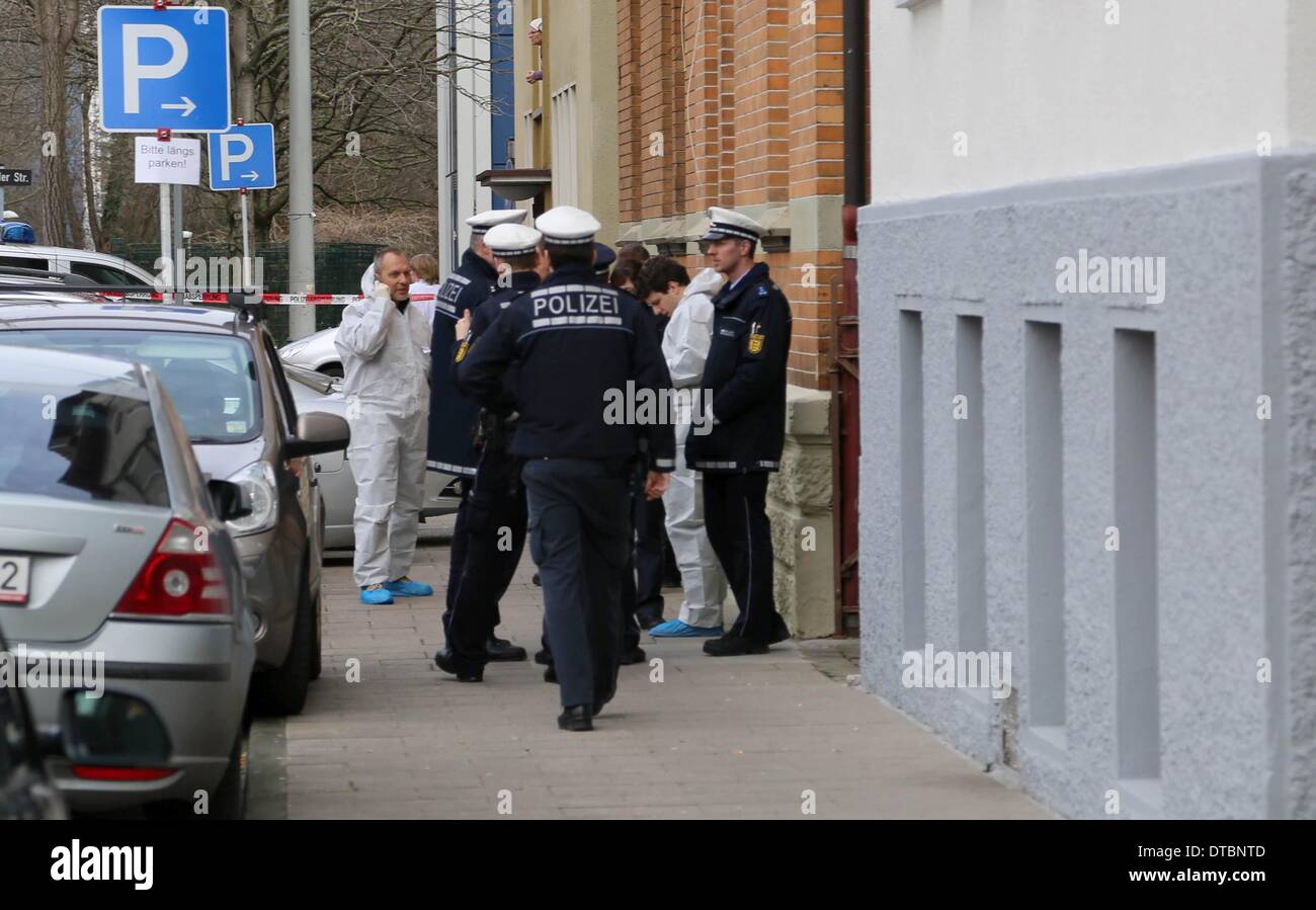 Forensics and police officers examine a crime scene after a man ...