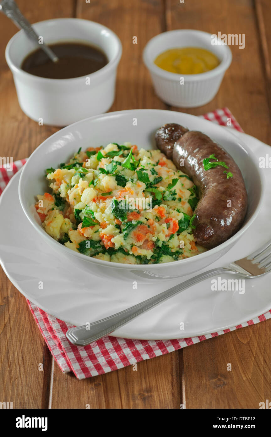 Stoemp and sausage. Mashed potatoes with carrots and spinach. Belgium ...