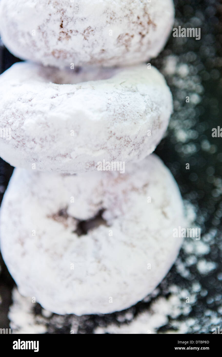 Fresh donuts with powdered sugar toppings from the local bakery shop ...
