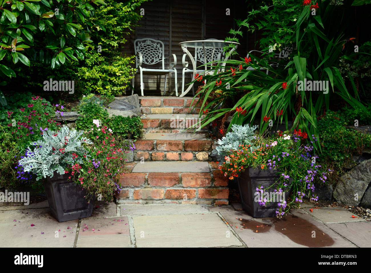 raised patio seating area red brick steps container container gardening ...