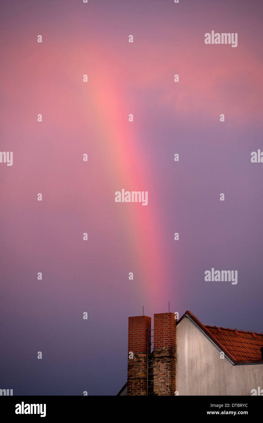 Rainbow over a house Stock Photo - Alamy