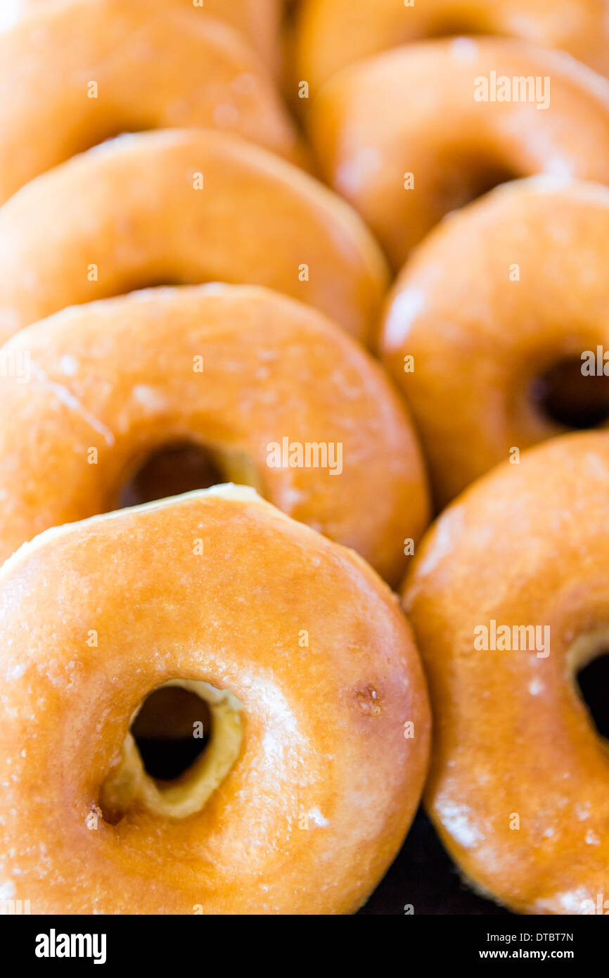 Fresh raised donuts from the local bakery shop Stock Photo - Alamy