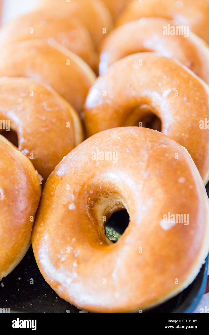 Fresh raised donuts from the local bakery shop Stock Photo - Alamy
