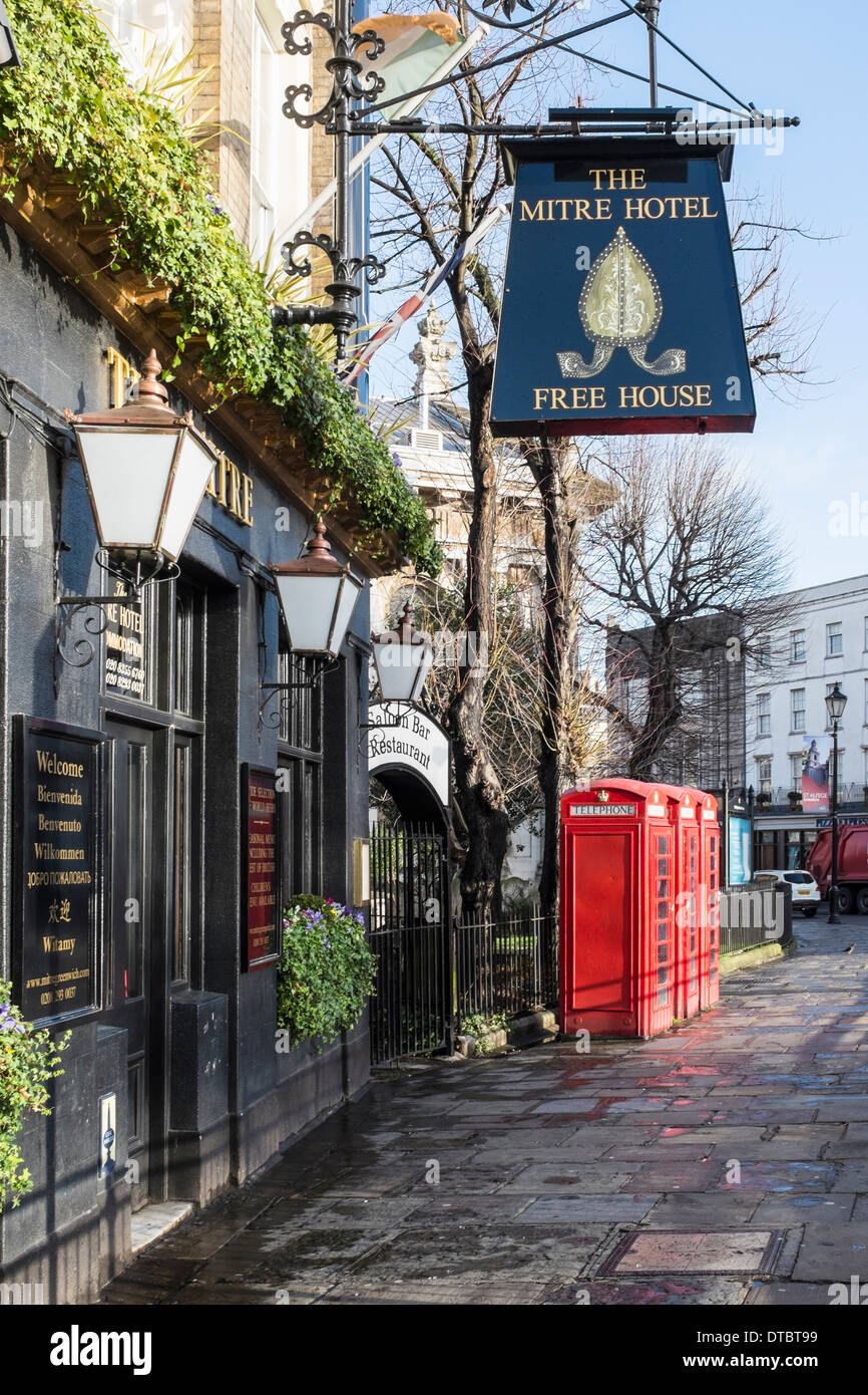 The Mitre Hotel free house pub sign and traditional red telephone boxes ...
