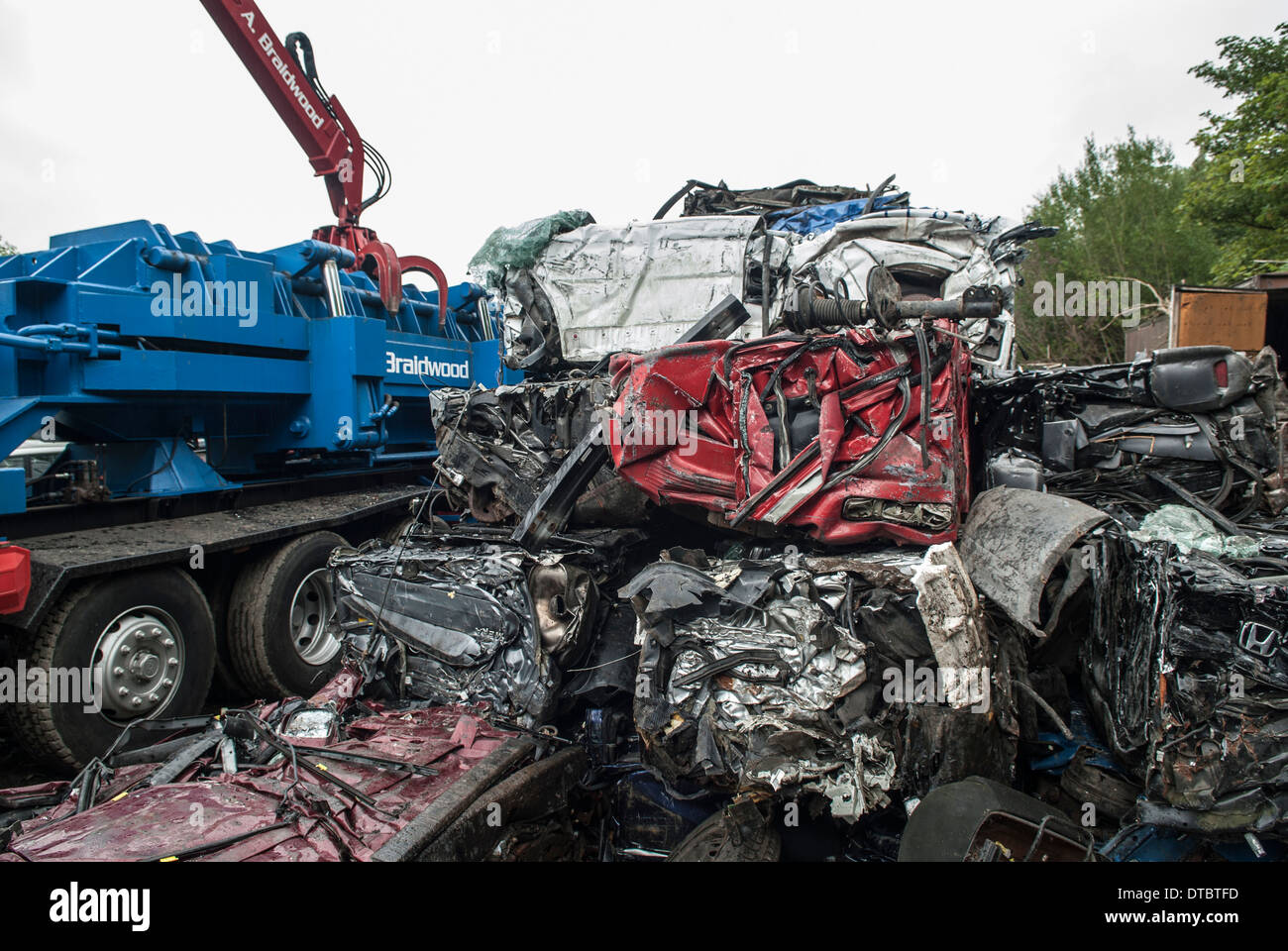 Crushed cars in scrap yard UK Stock Photo - Alamy