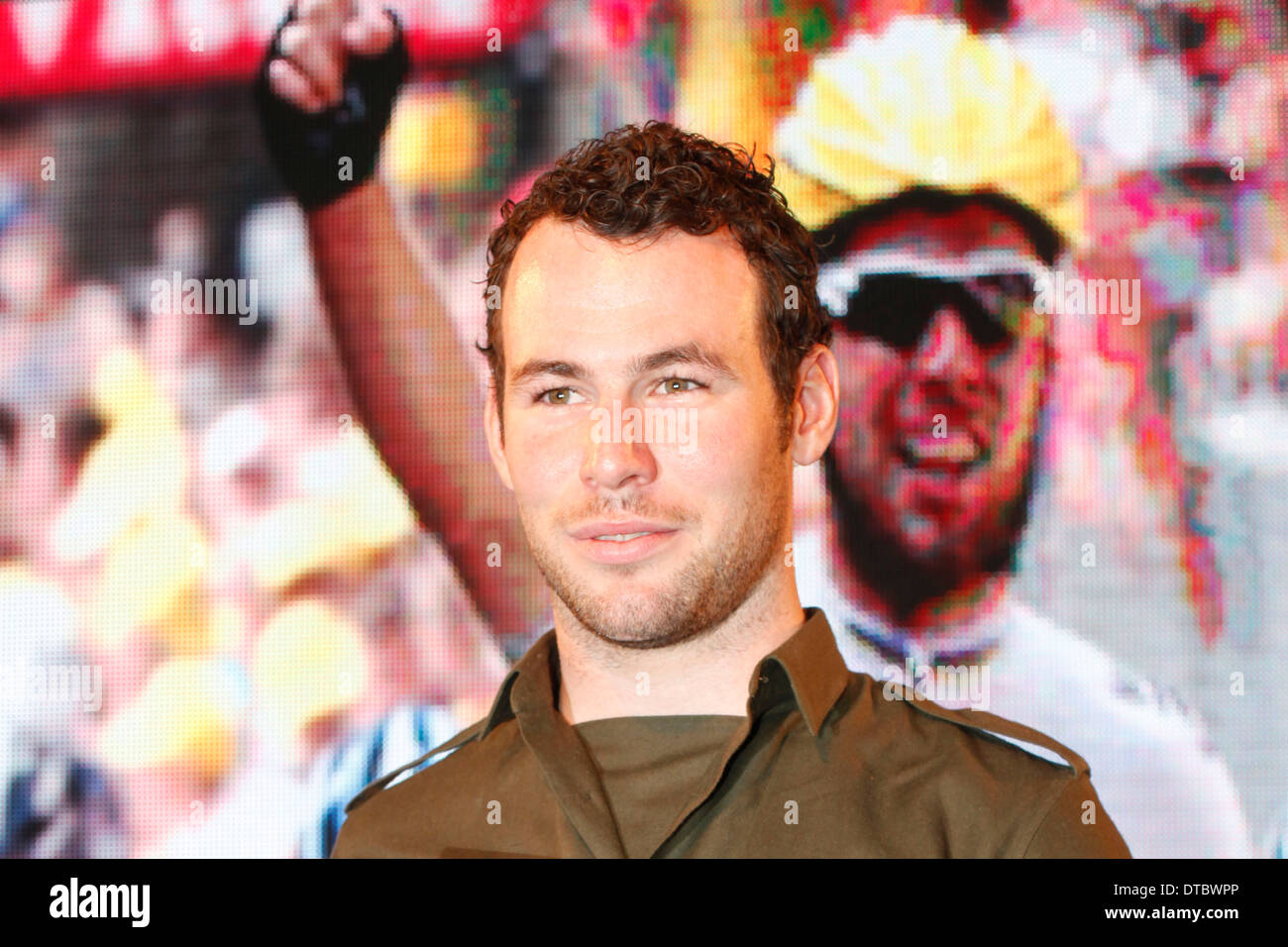 Mark Cavendish poses for a photograph during a signing event to his new ...
