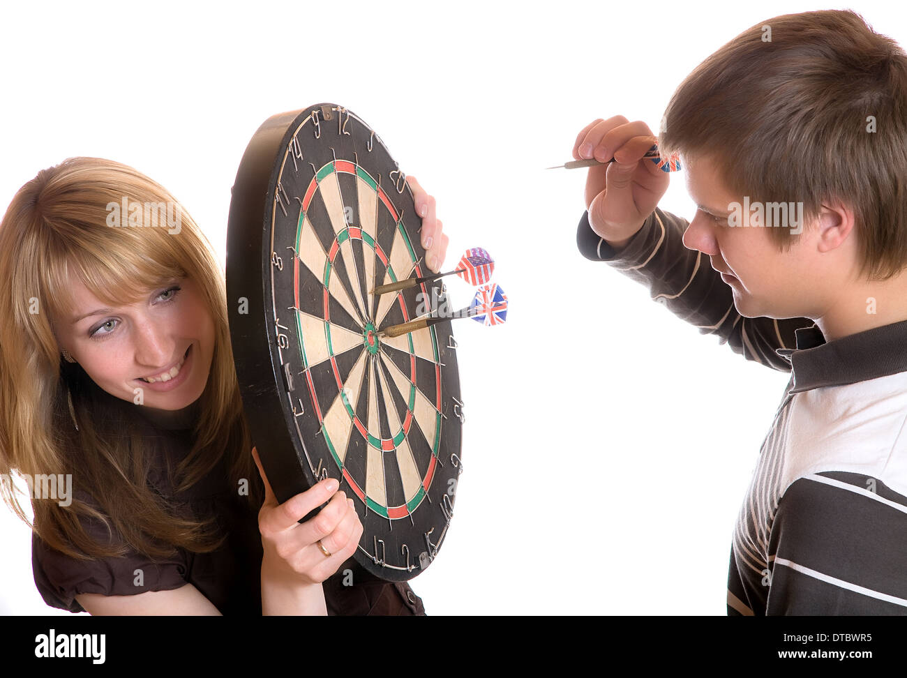 The young man and girl play a darts on white background Stock Photo - Alamy