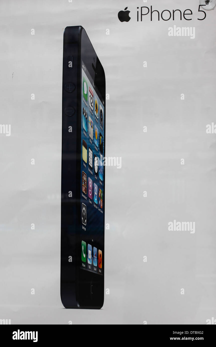 A mobile phones store displays a poster of the new Apple iPhone 5 phone ...
