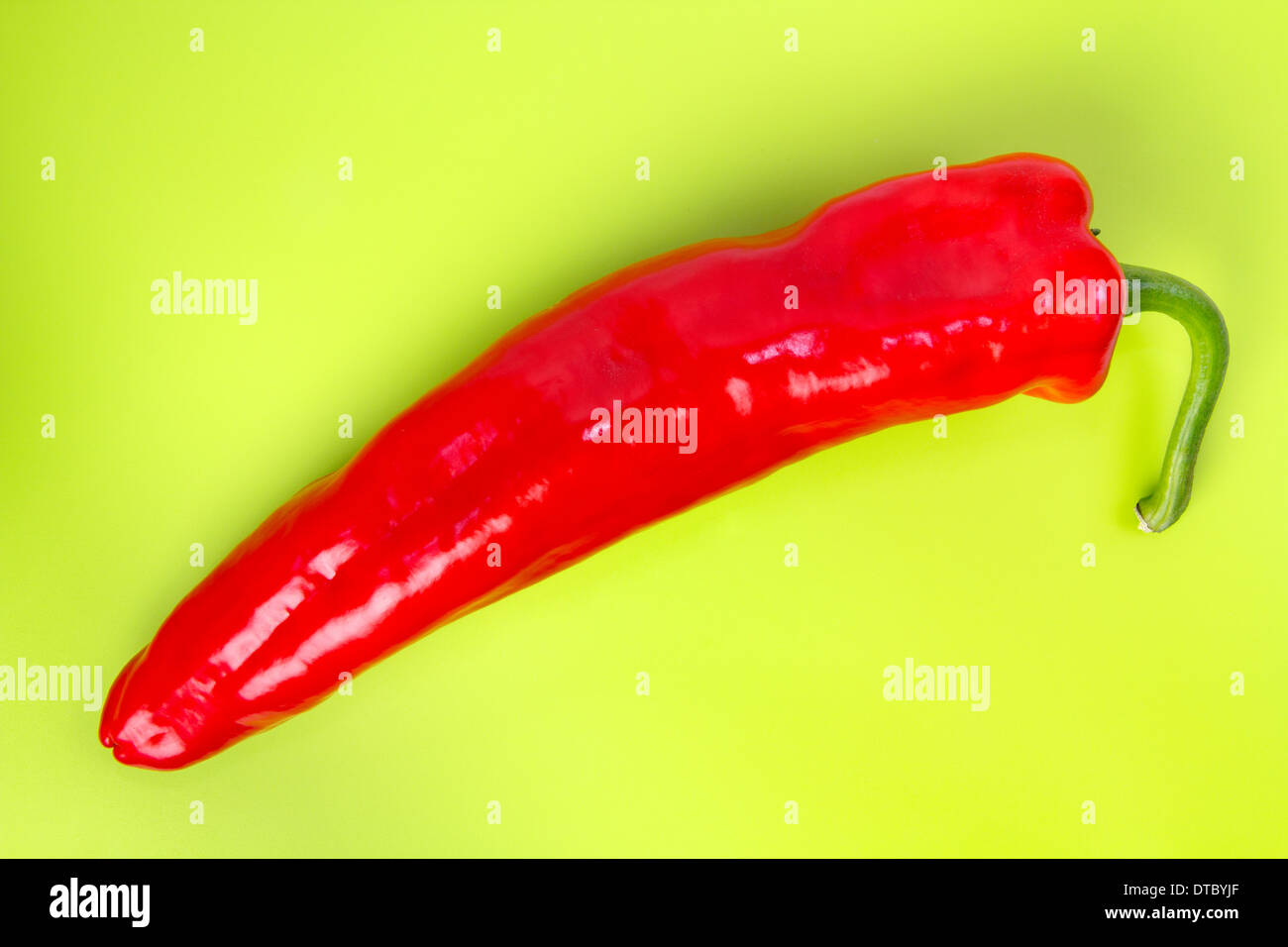 Large pointed pepper against green background Stock Photo - Alamy