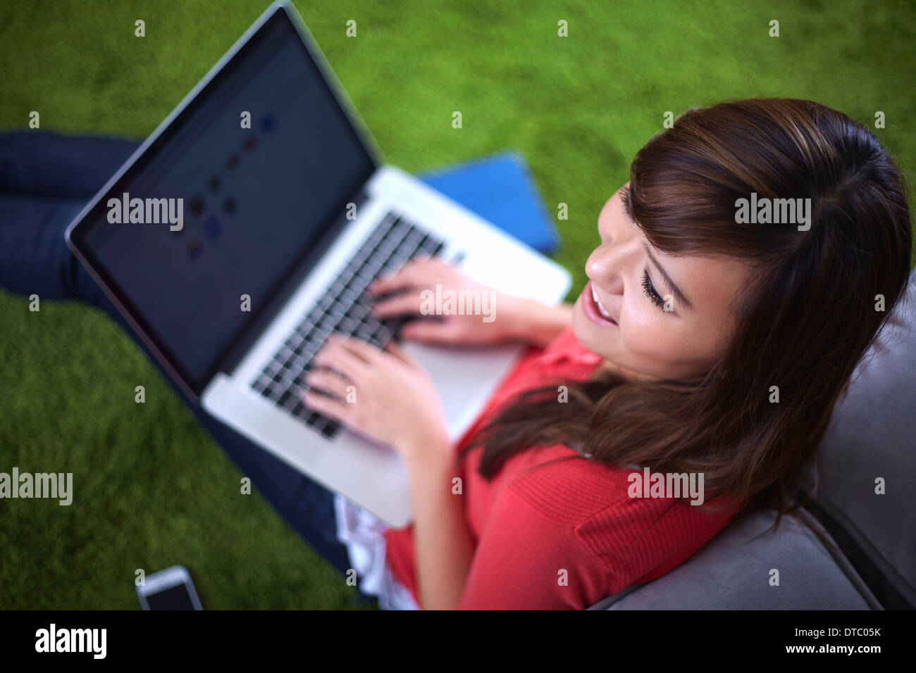 Young woman sitting on rug hi-res stock photography and images - Alamy