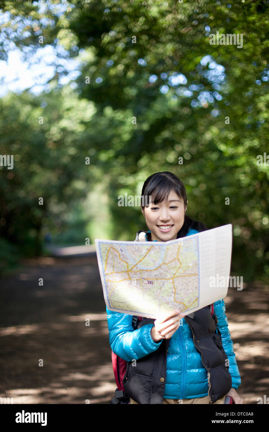 Young female hiker looking at map Stock Photo - Alamy