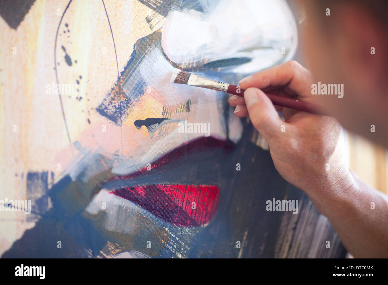 Hand holding artists brush on abstract painting hi-res stock ...