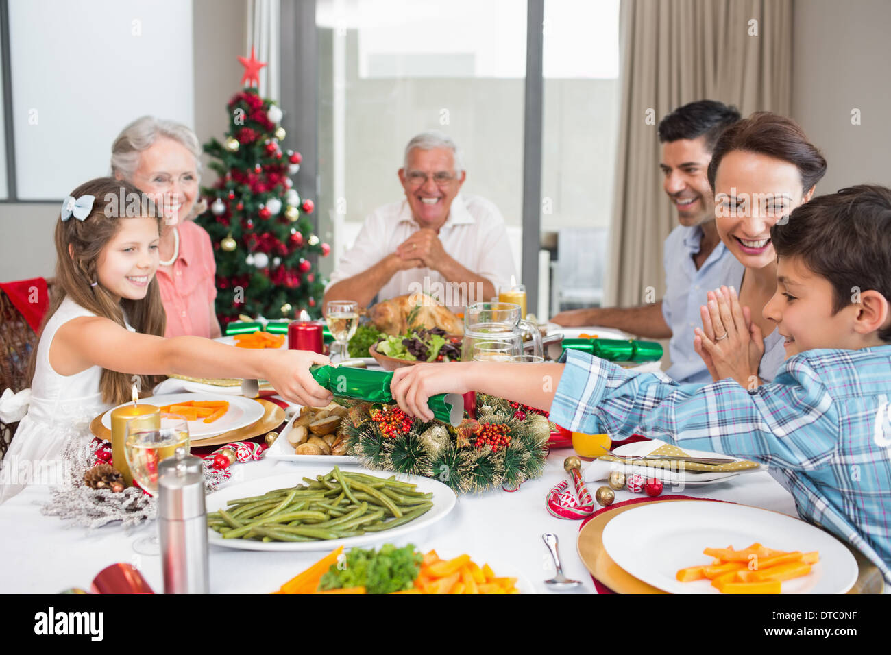 Cheerful family at dining table for christmas dinner Stock Photo - Alamy