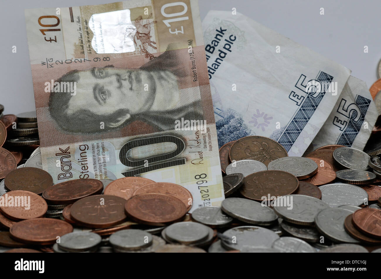 Various coins and notes against a white background. Currency of Britain ...
