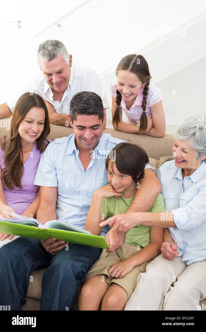 Happy family reading book Stock Photo - Alamy