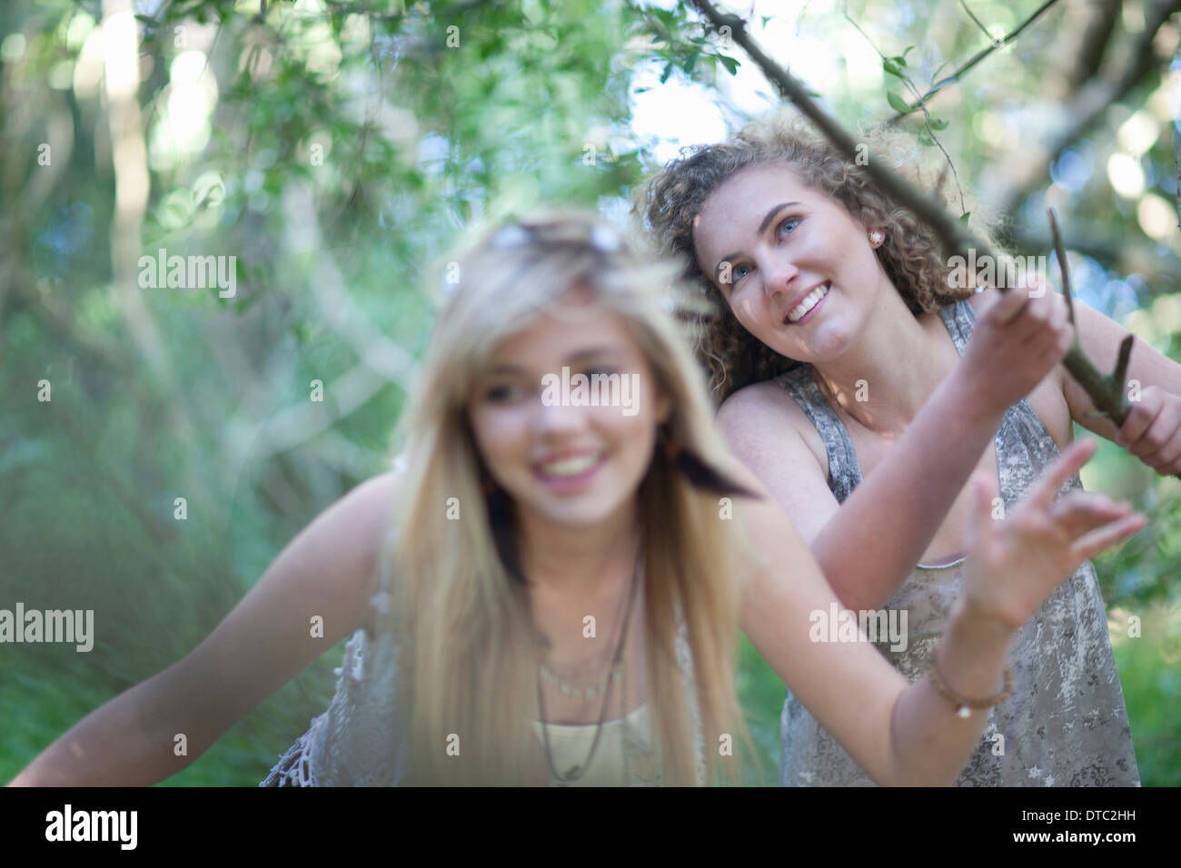 Two teenage girls discovering woodland Stock Photo - Alamy