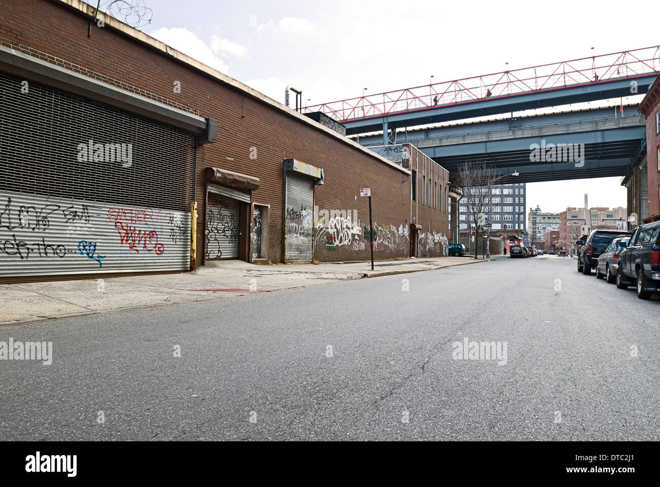 Deserted dangerous empty urban street scene with old warehouse ...