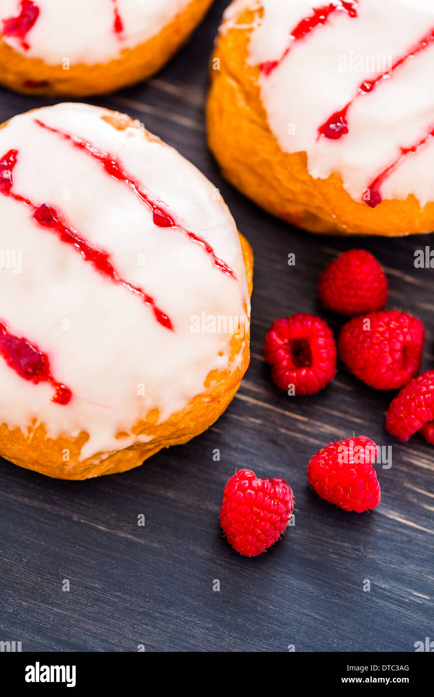 Fresh raspberry jelly filled donuts with white glazing on top Stock ...