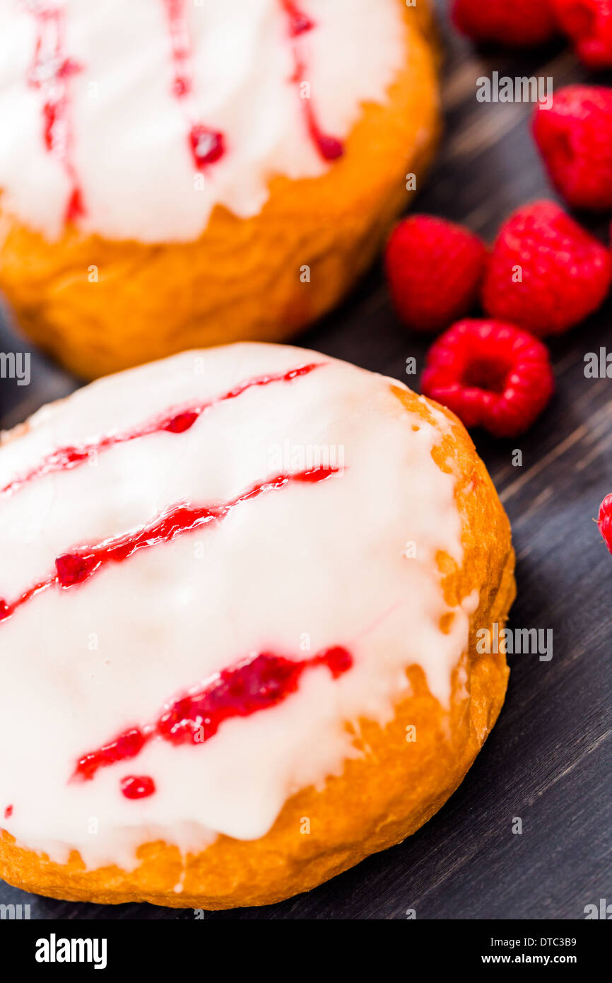 Fresh raspberry jelly filled donuts with white glazing on top Stock ...