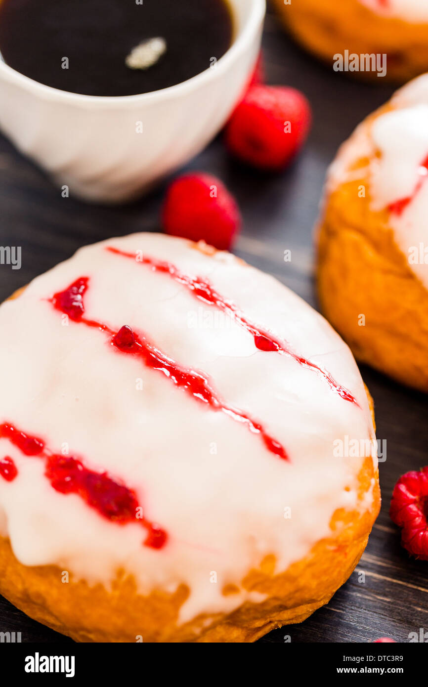 Fresh raspberry jelly filled donuts with white glazing on top Stock ...
