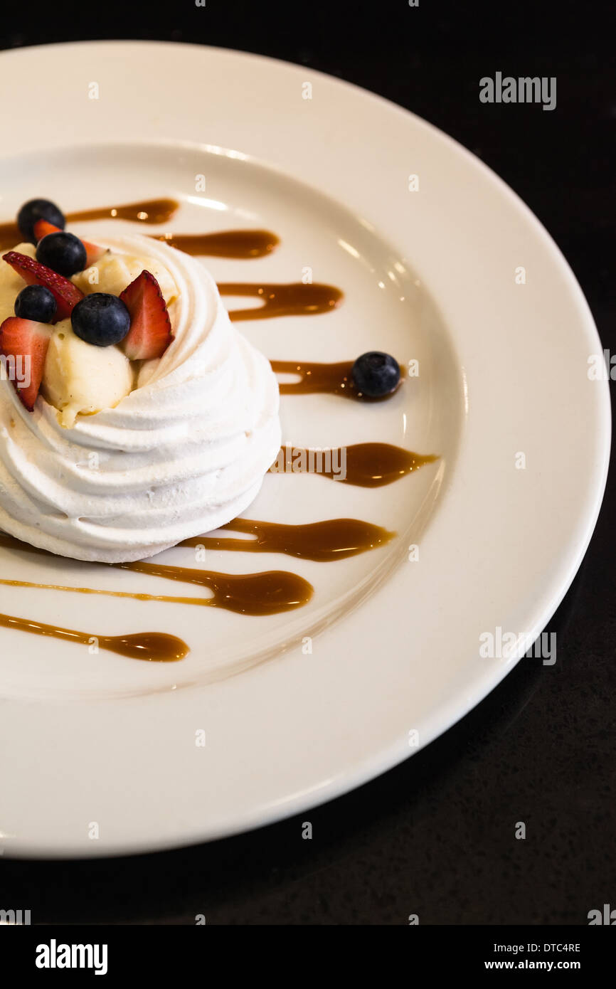 Meringue dessert with fruit and sauce Stock Photo - Alamy