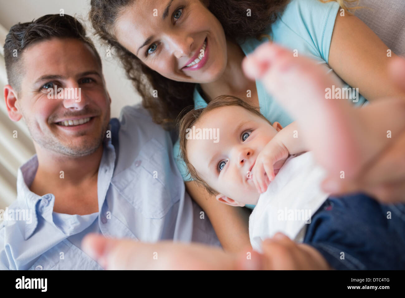 Smiling parents with cute baby Stock Photo - Alamy