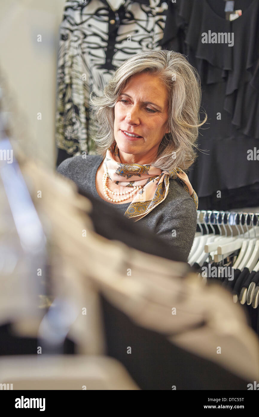 Woman browsing inside store Stock Photo - Alamy