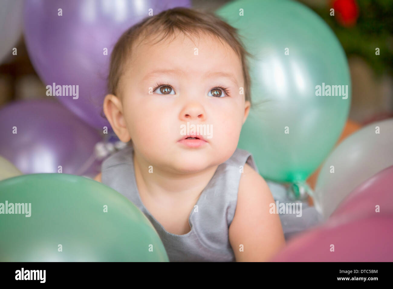 Baby girl with balloons Stock Photo - Alamy