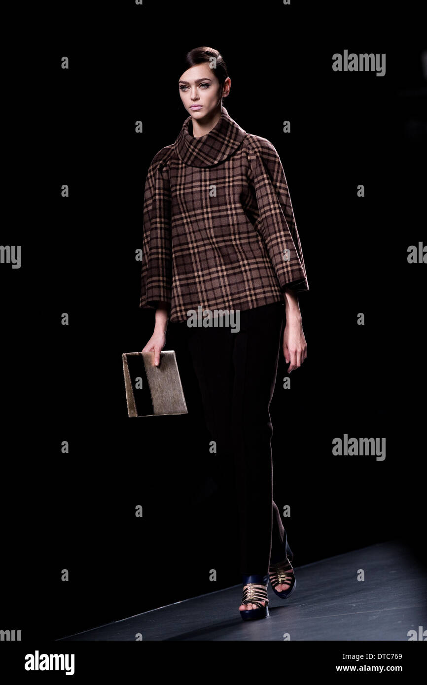Madrid, Spain. 14th Feb, 2014. A model showcases designs by Devota y ...