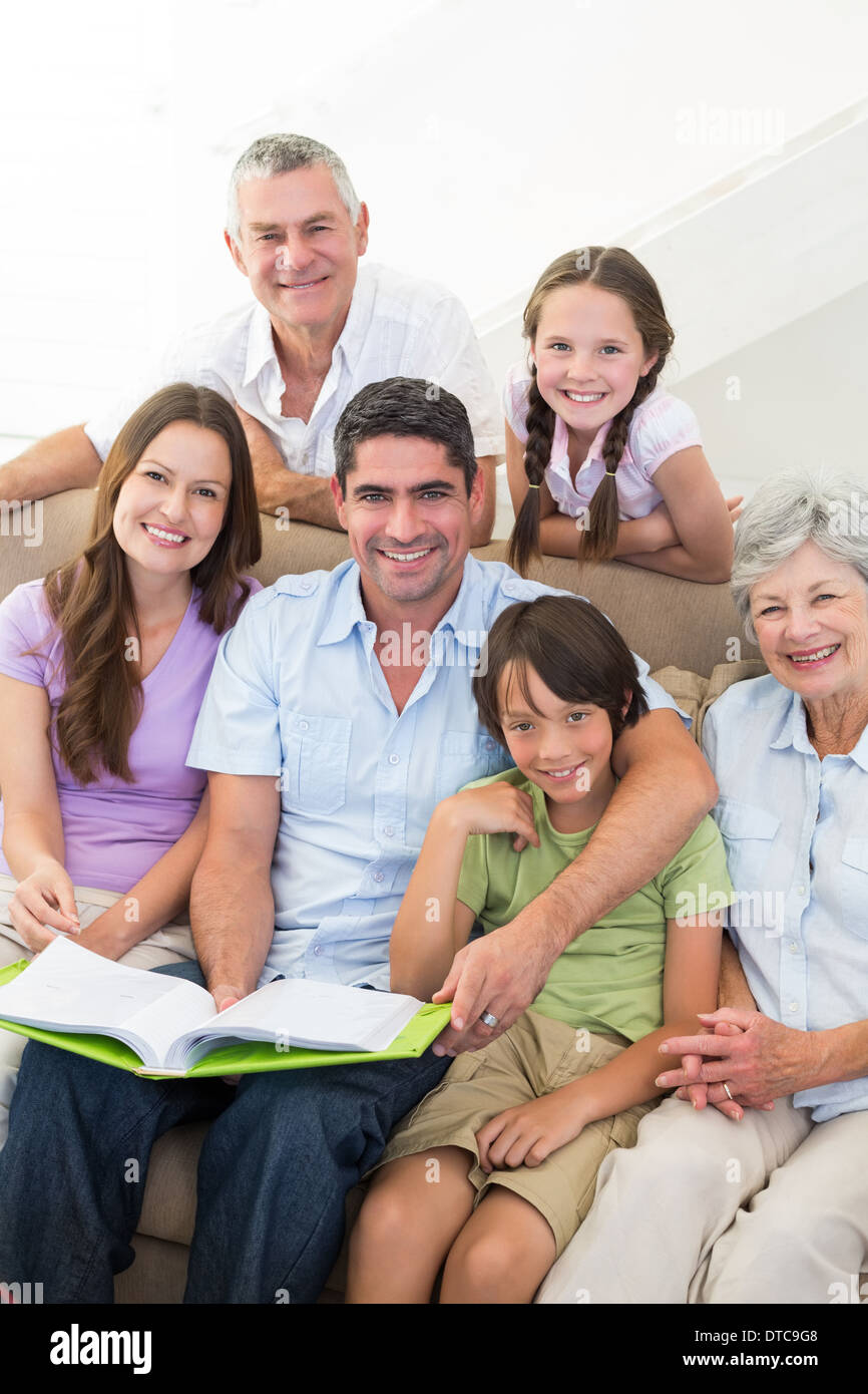 Happy multigeneration family with book Stock Photo - Alamy
