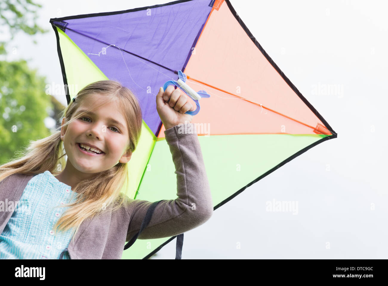 Portrait of a cute girl with a kite Stock Photo - Alamy