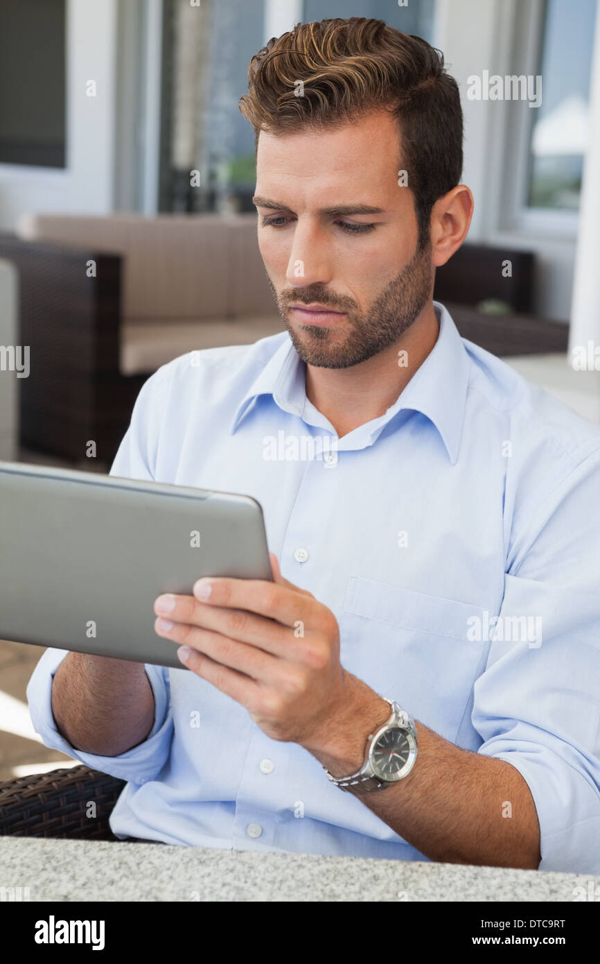 Serious young businessman working on tablet Stock Photo - Alamy