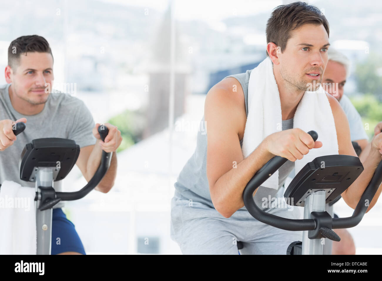 Men using exercise bikes Stock Photo - Alamy