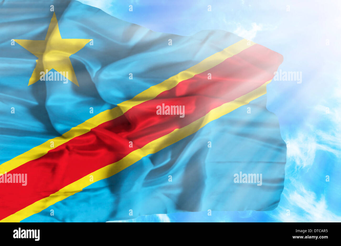 Congo Democratic Republic waving flag against blue sky with sunrays ...