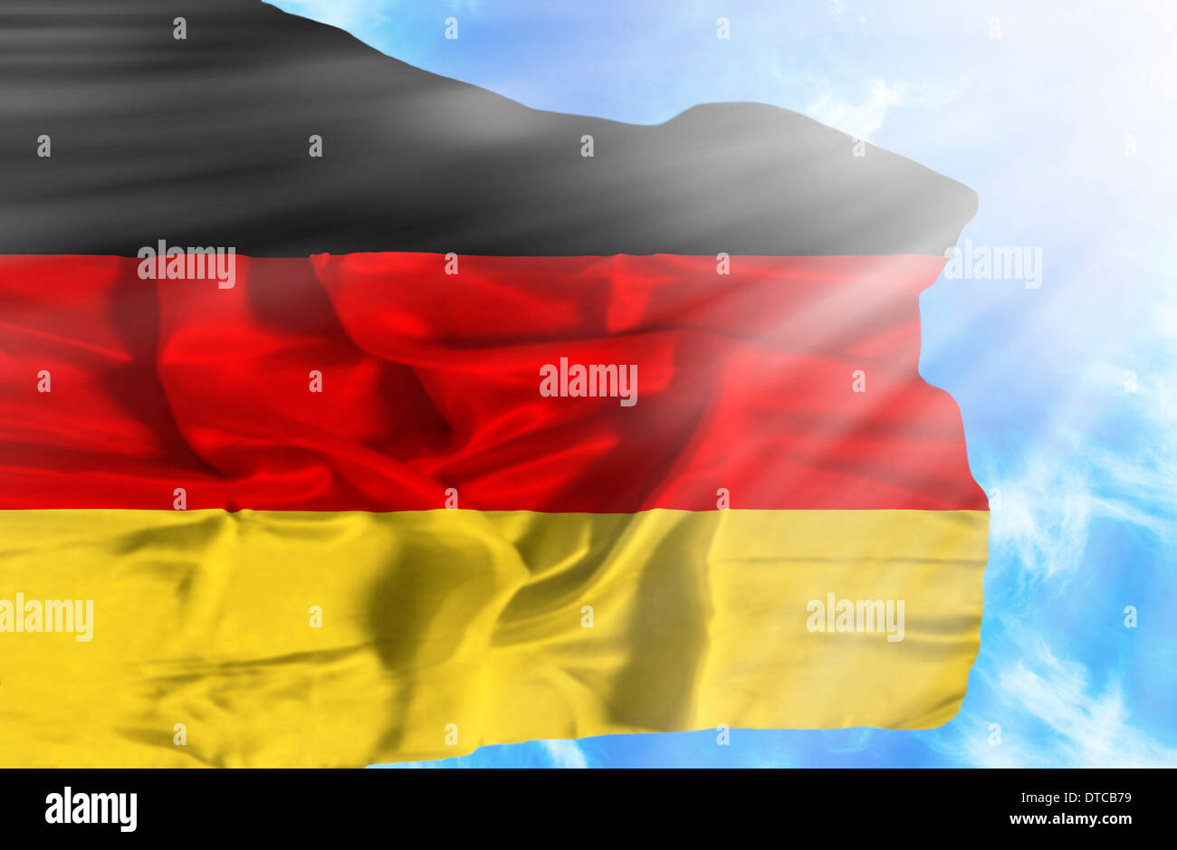 Germany waving flag against blue sky with sunrays Stock Photo - Alamy
