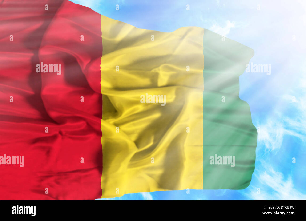 Guinea waving flag against blue sky with sunrays Stock Photo - Alamy